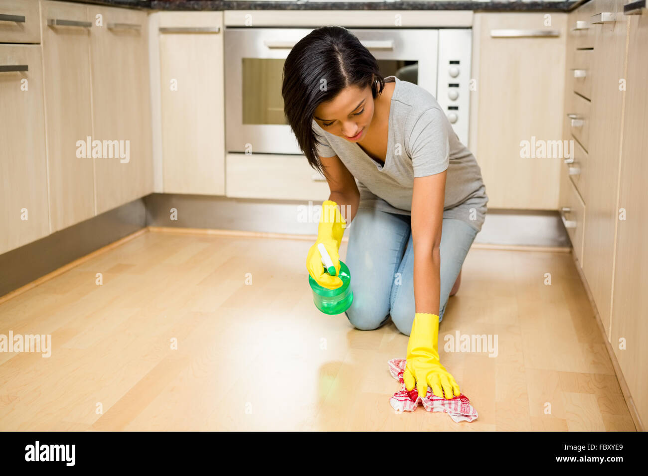 Attractive brunette cleaning the floor Stock Photo - Alamy