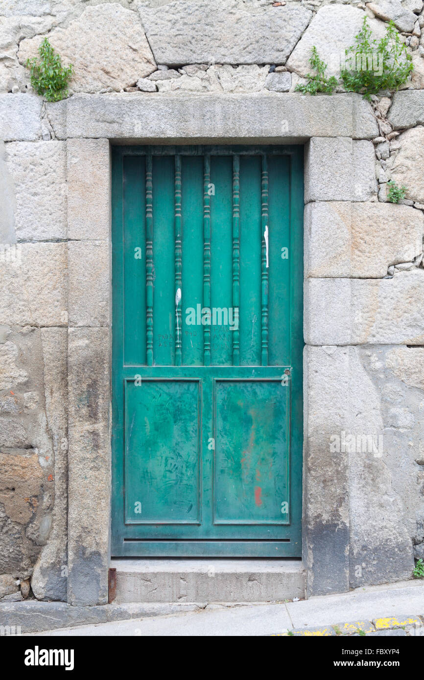 Cyan wooden Door in Stone Wall Stock Photo - Alamy