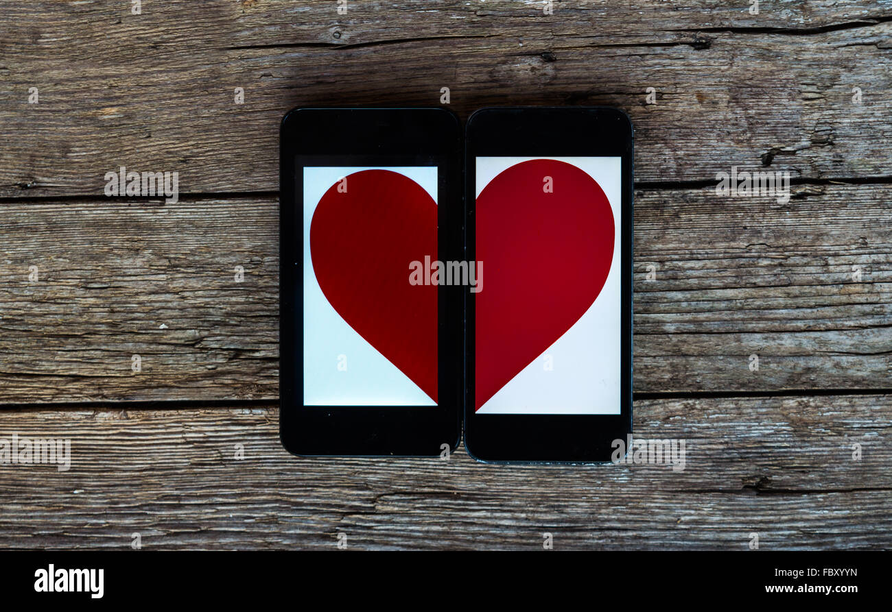 Two Cellphone With Half Heart Symbol on wooden background Stock Photo ...