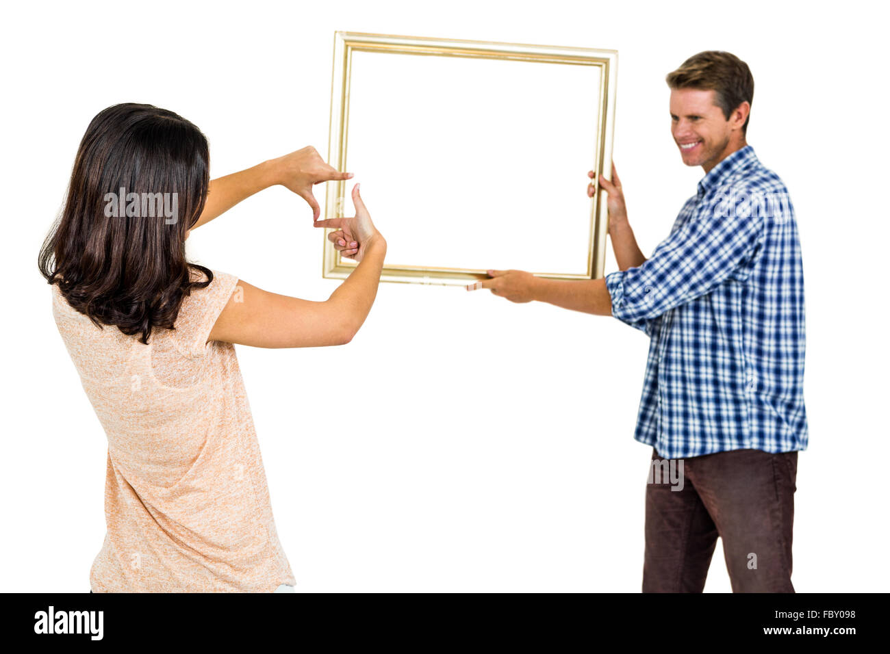 Happy young couple hanging picture frame Stock Photo - Alamy