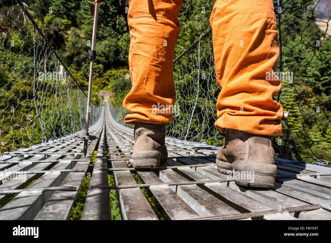 Closeup of boots standing on a suspension bridge Stock Photo - Alamy