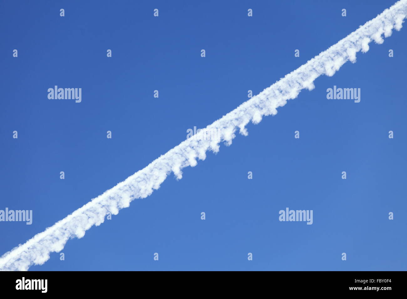 Airplane tracks in the blue sky Stock Photo - Alamy