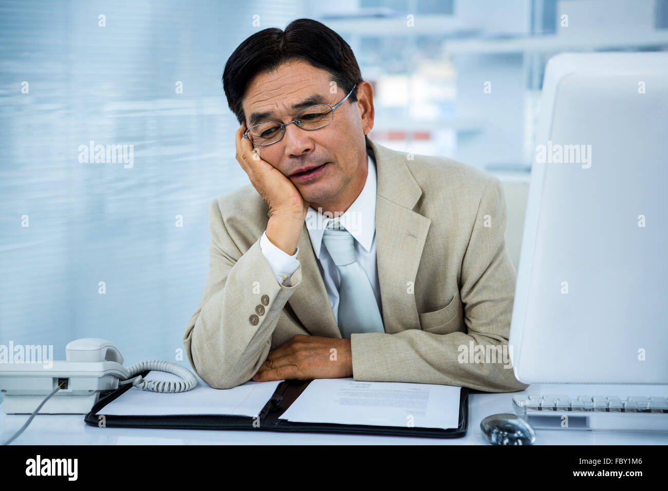 Tired businessman holding his head Stock Photo - Alamy