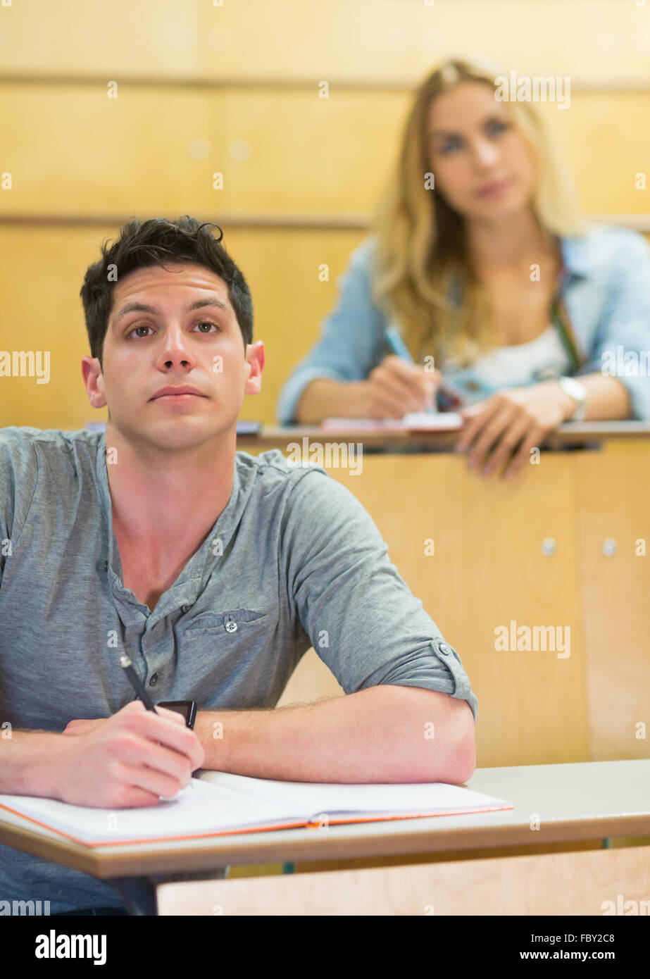 Thoughtful male student during class Stock Photo - Alamy