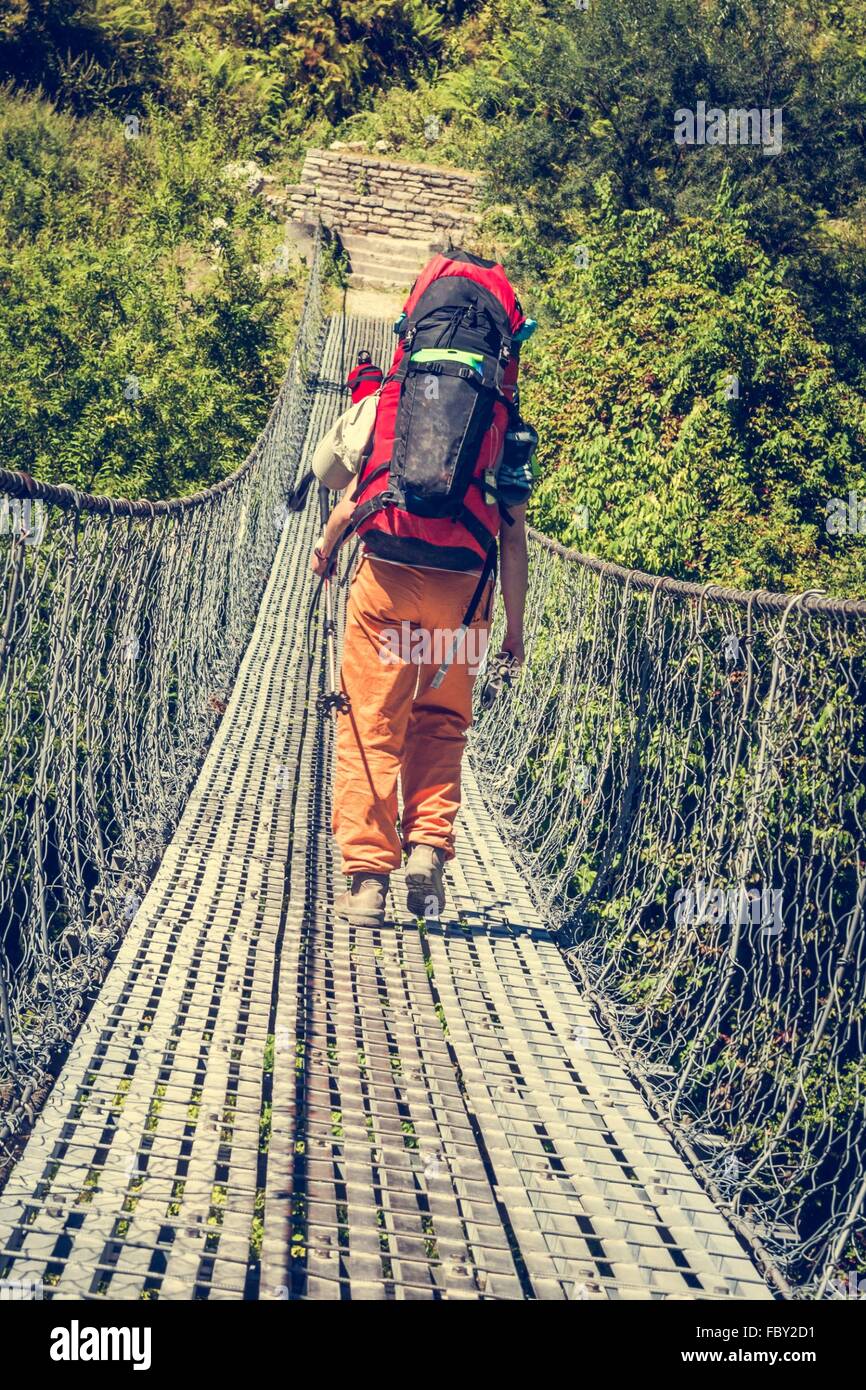 Female hiker crossing a suspension bridge Stock Photo - Alamy