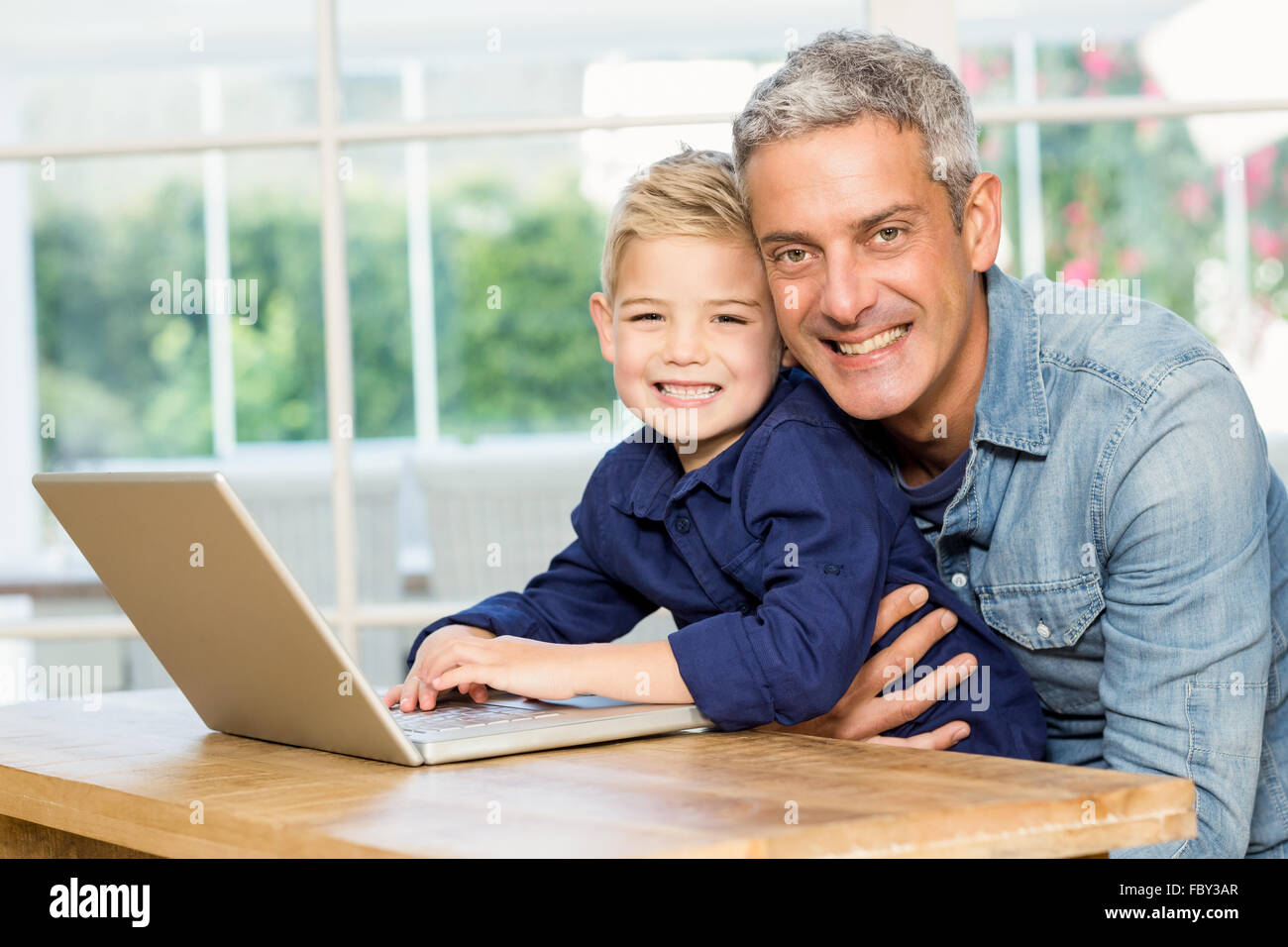 Father and son using laptop Stock Photo - Alamy