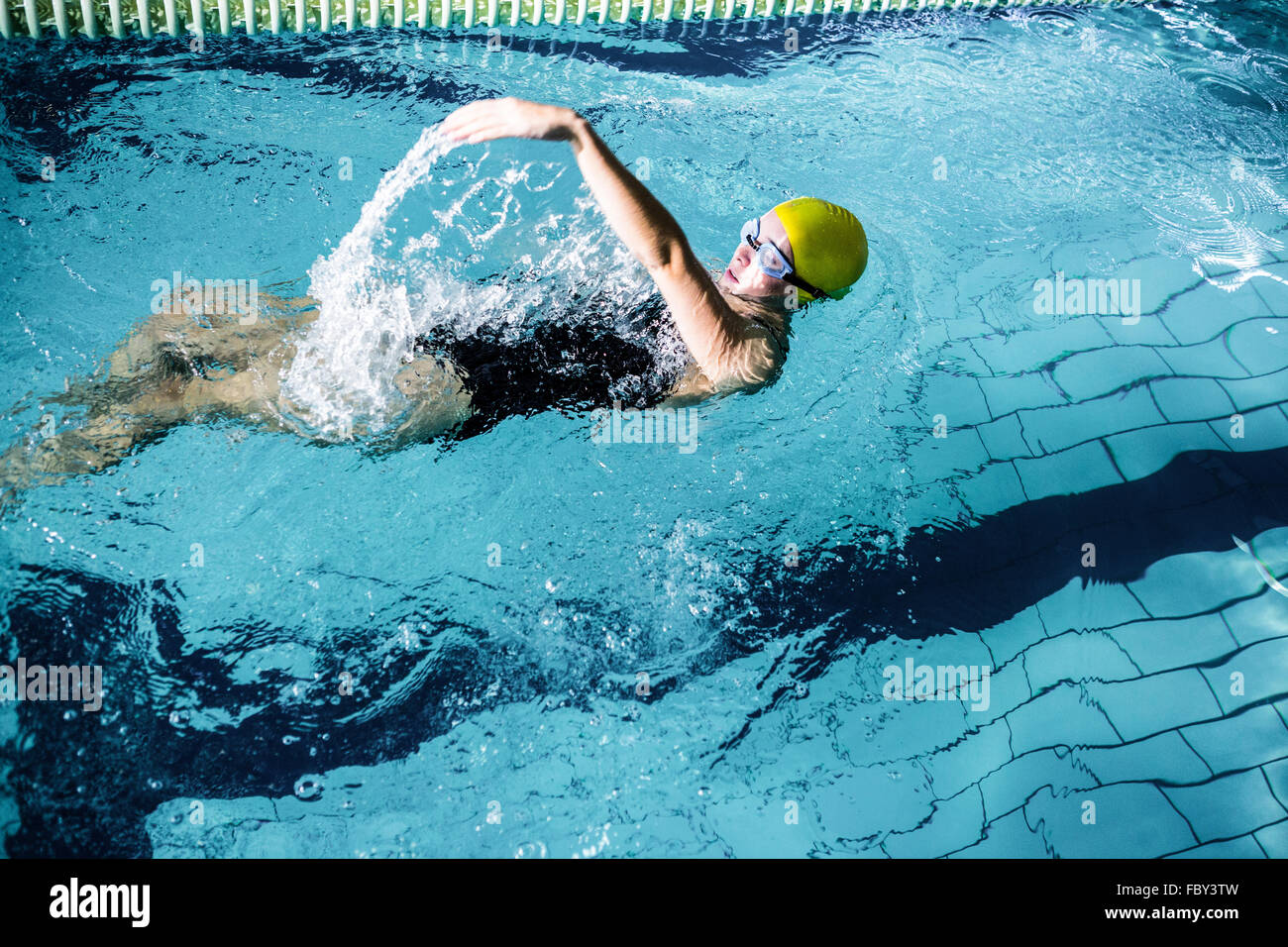 Fit female swimmer doing the back stroke Stock Photo - Alamy