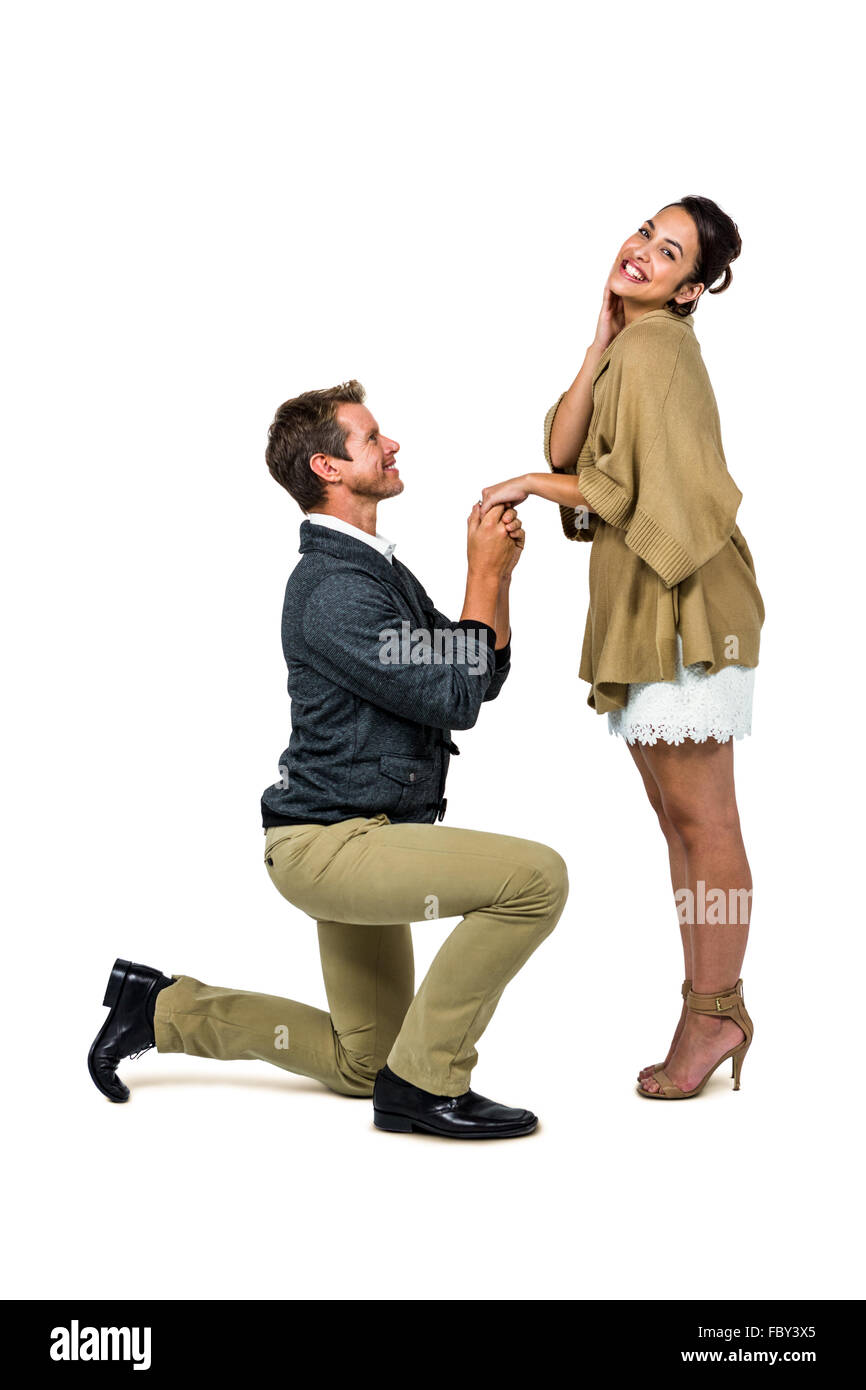 Man proposing woman while kneeling and holding hands Stock Photo - Alamy