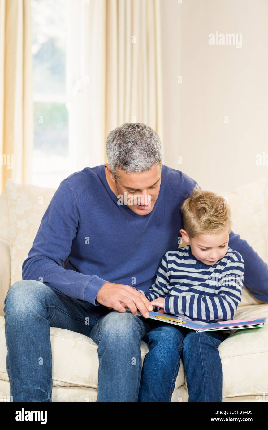 Father son holding book hi-res stock photography and images - Alamy