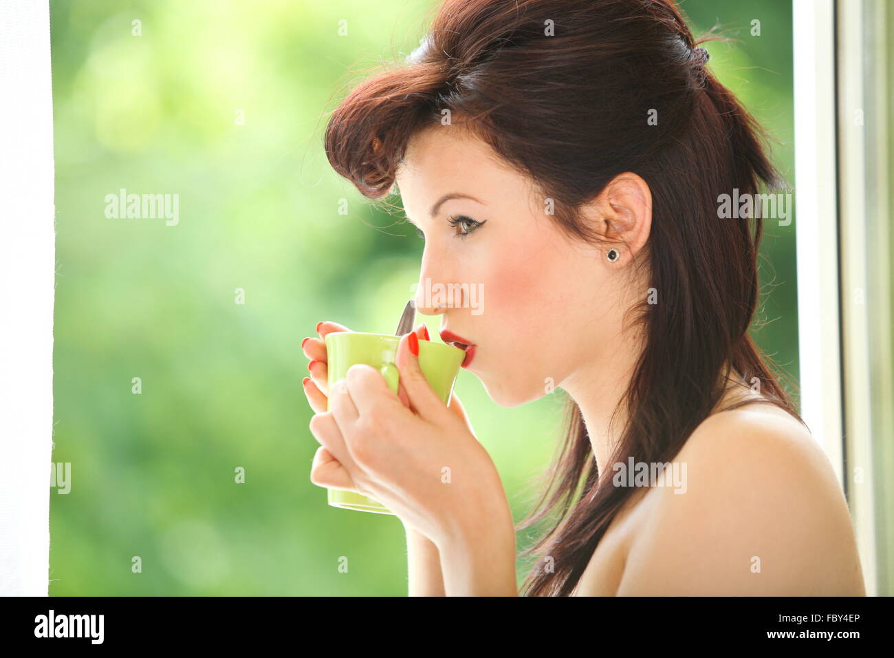 Beautiful Girl Drinking Tea or Coffee Stock Photo - Alamy
