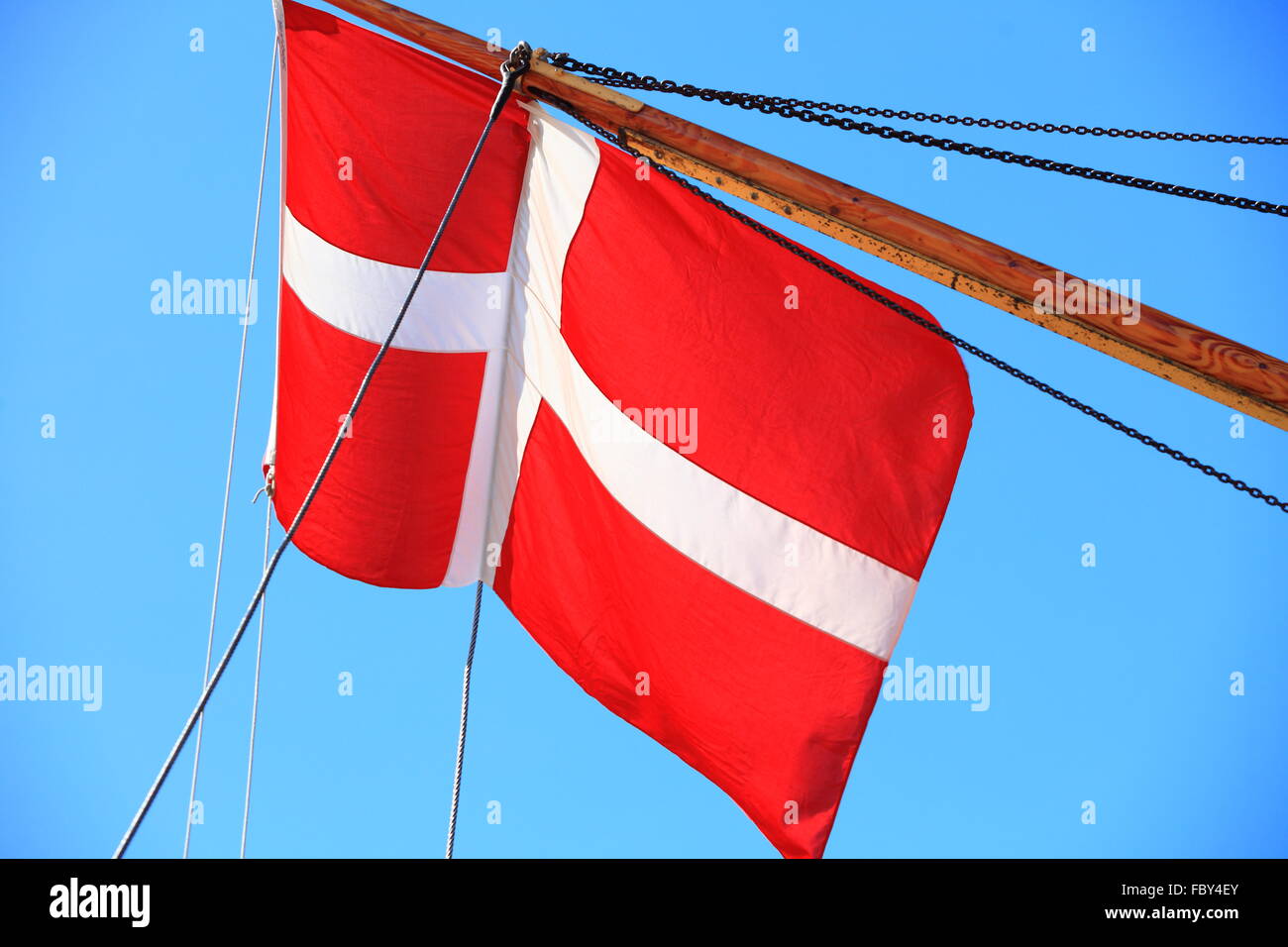 danish flag on ship blue sky background Stock Photo - Alamy