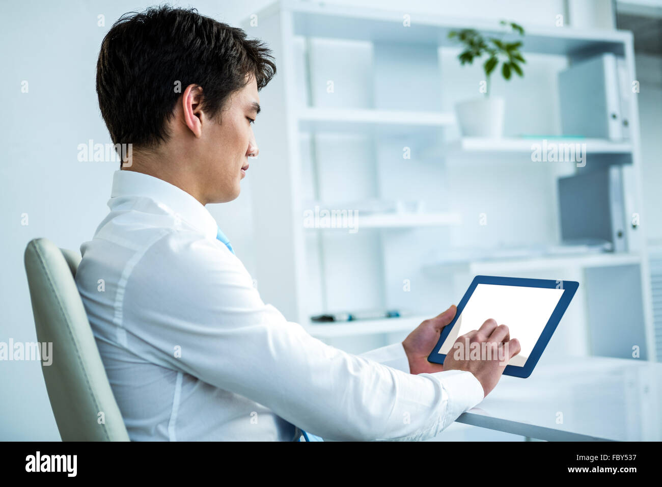 Asian man using tablet Stock Photo - Alamy