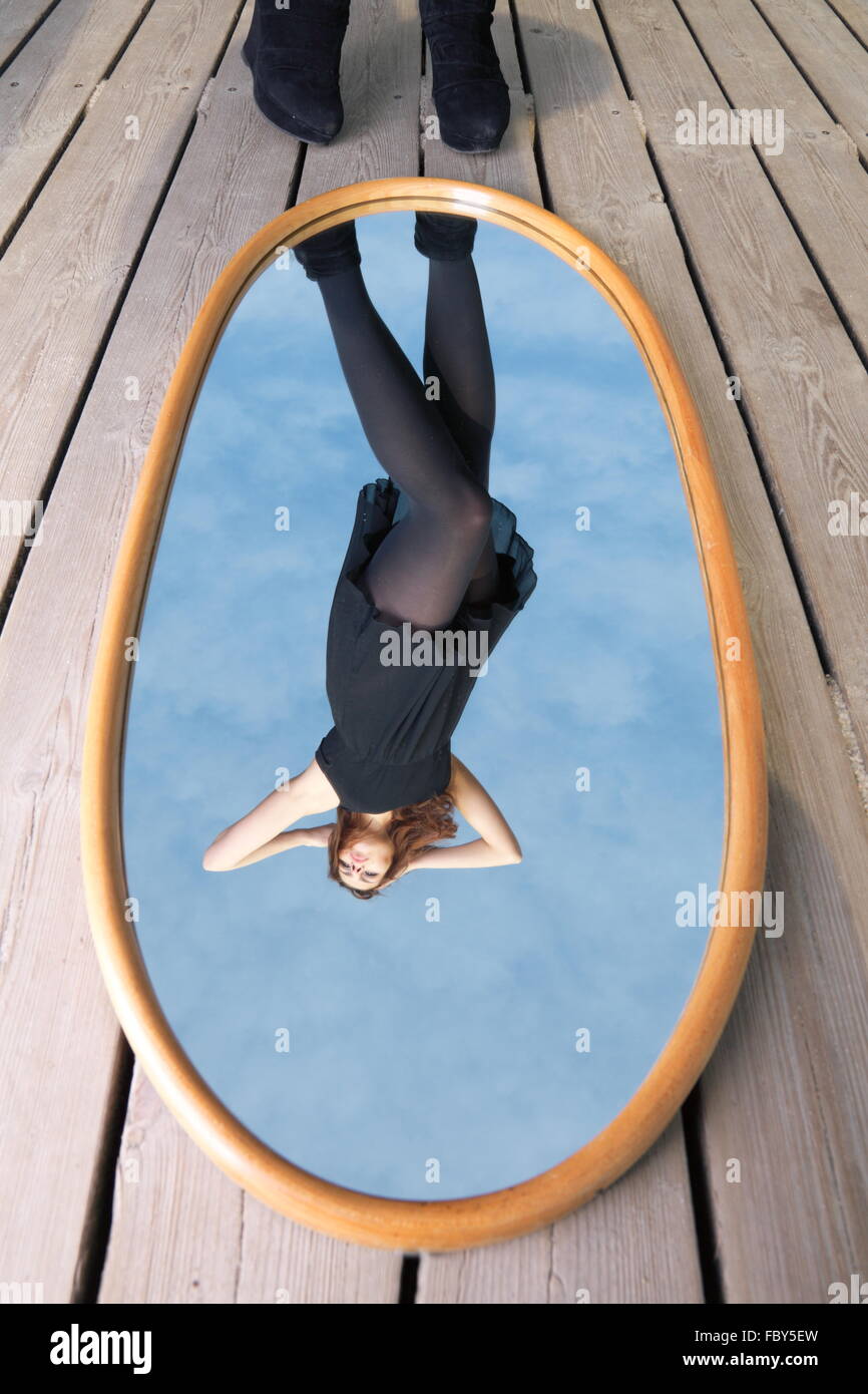 thoughtful woman with her reflection in mirror Stock Photo - Alamy