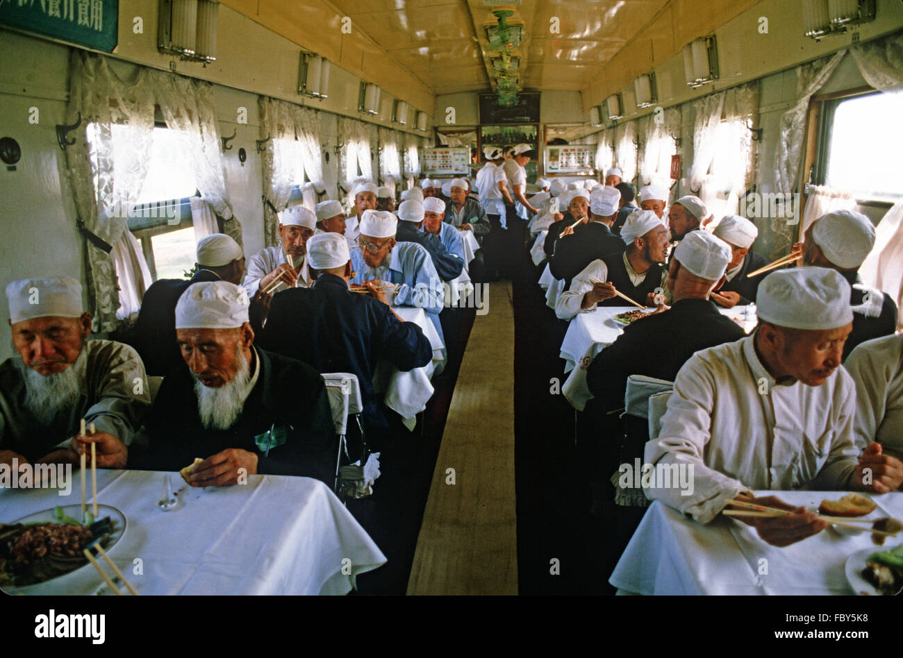 Chinese Muslim pilgrims in train dinning car from Yinchaun, Ningxia ...