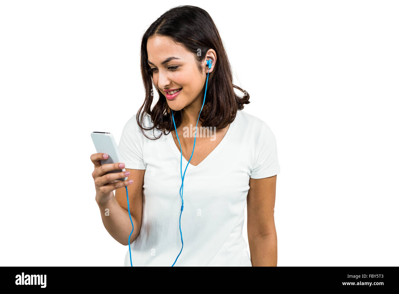 Happy woman listening music while using mobile phone Stock Photo - Alamy