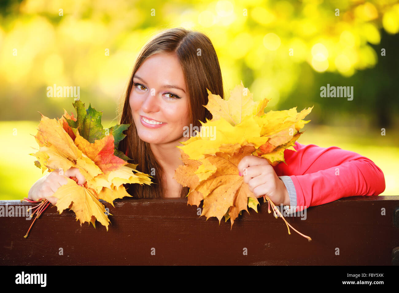 Fall season. Portrait girl woman holding autumnal leaves in park Stock ...