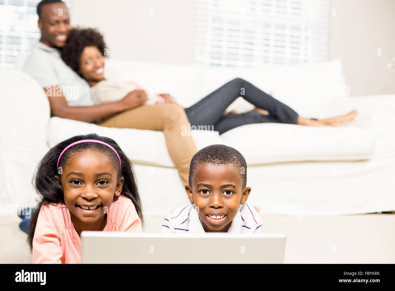 Happy kids using laptop pc Stock Photo - Alamy