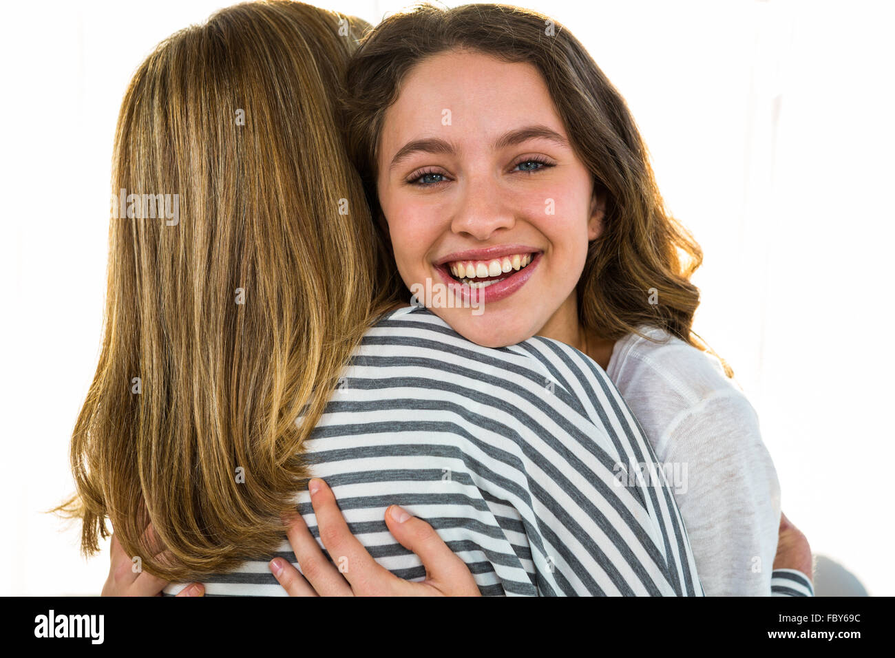Mother and daughter hugging Stock Photo - Alamy