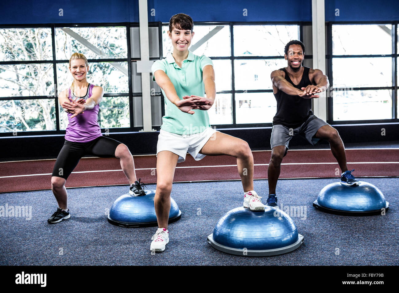 Fit people doing exercise with bosu ball Stock Photo - Alamy