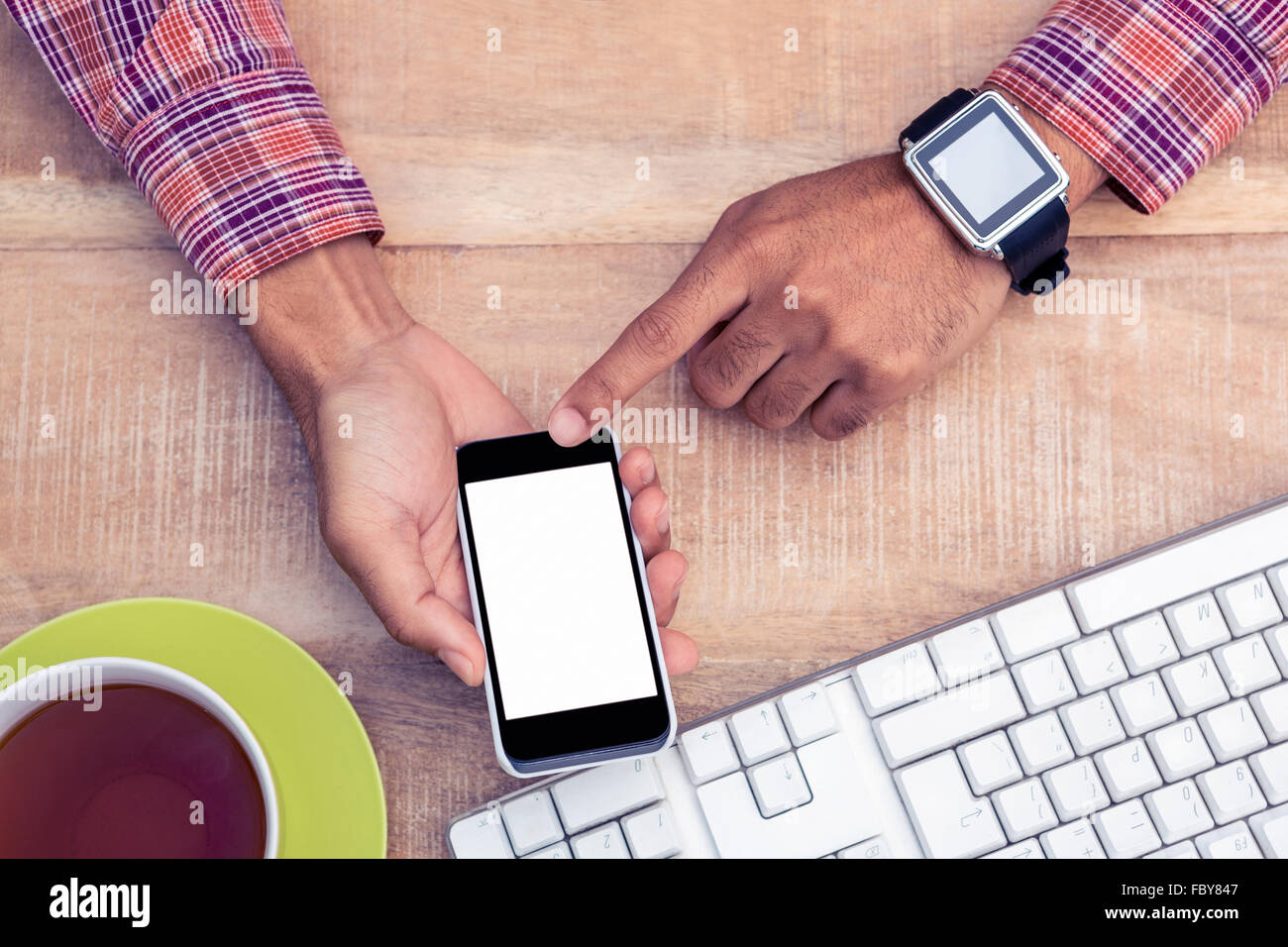 Man using smart phone on desk Stock Photo - Alamy