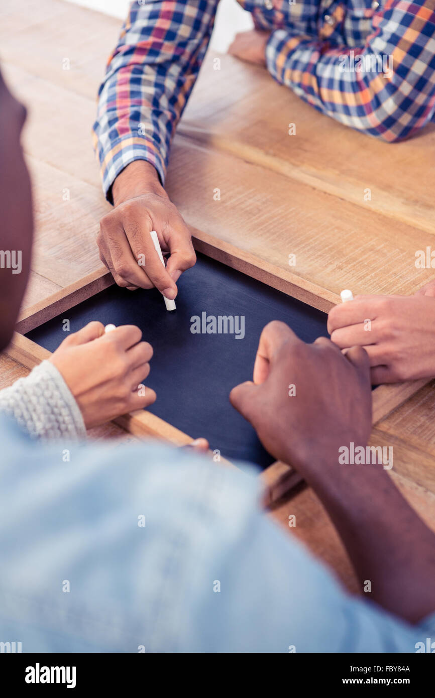 High angle view of business people writing on slate Stock Photo - Alamy