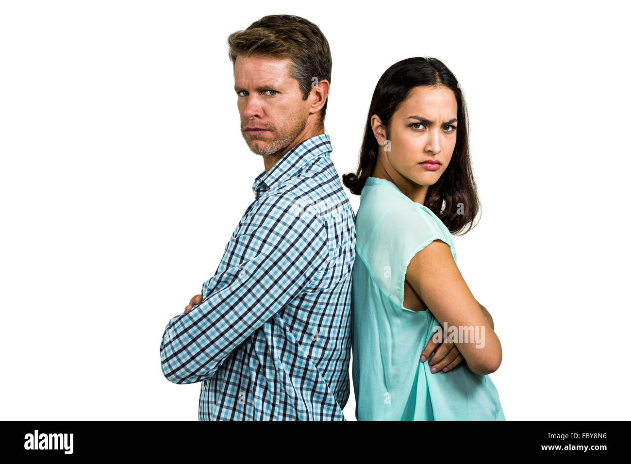 Portrait of angry couple standing back to back Stock Photo - Alamy