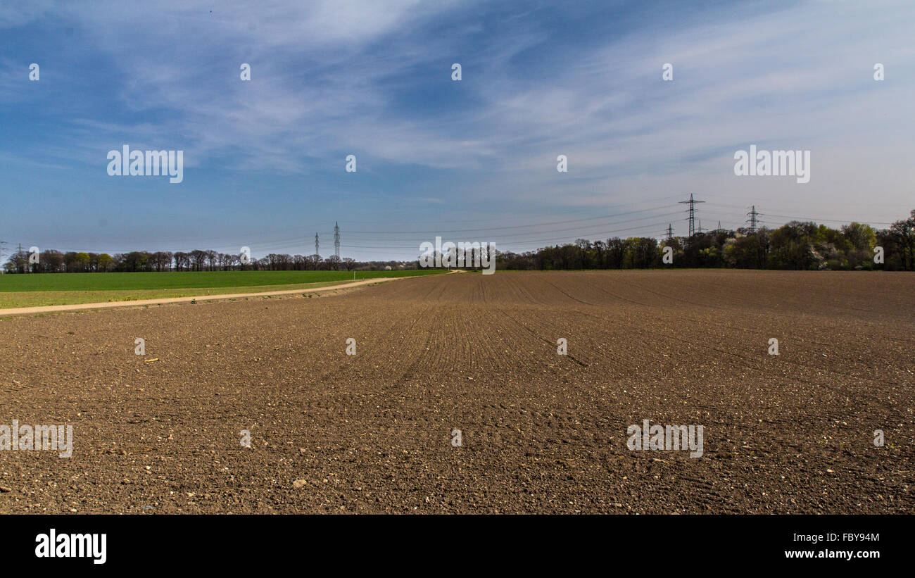 Agricultural landscape with plowed field Stock Photo - Alamy