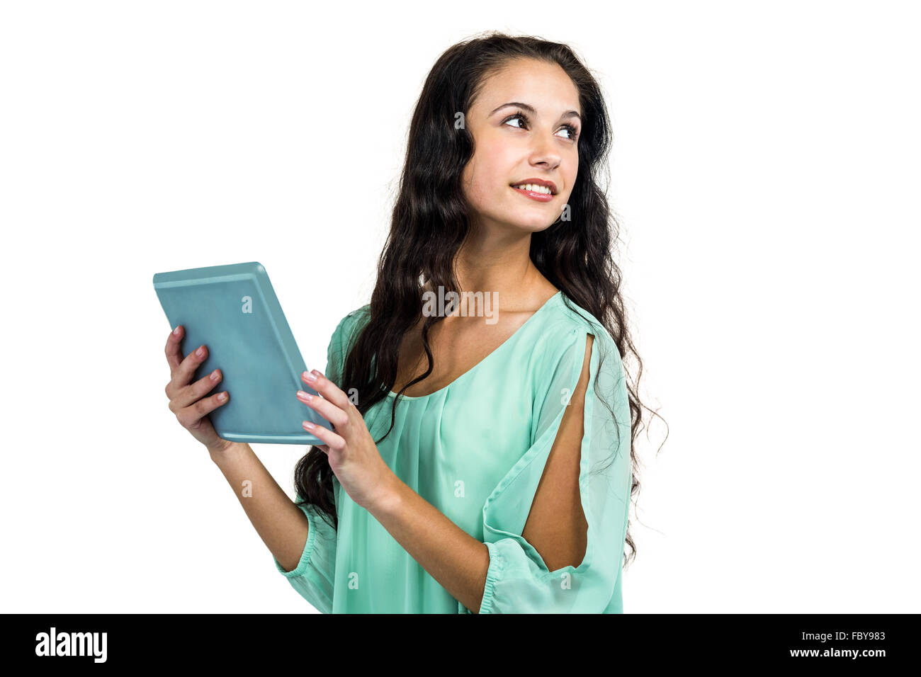 Smiling woman holding tablet and looking away Stock Photo - Alamy