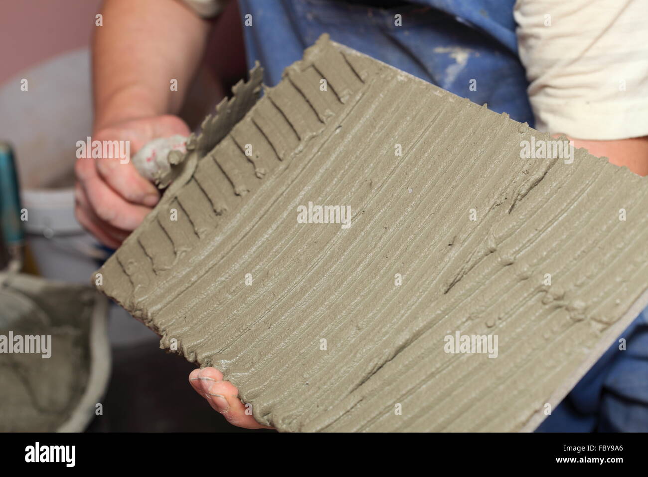 Construction worker is tiling at home tile floor adhesive Stock Photo ...