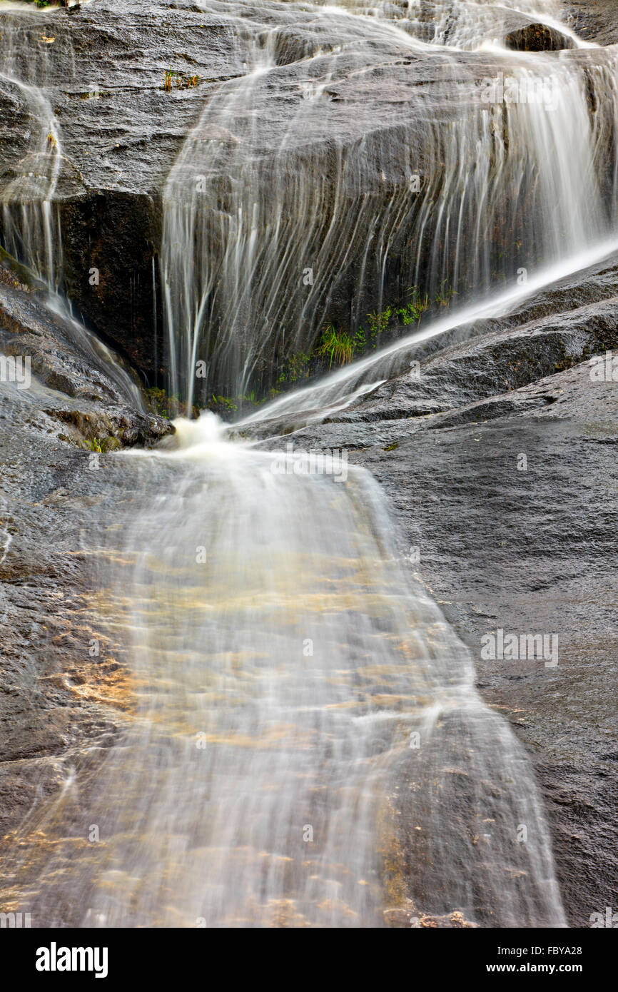 Noname waterfall running down on the hard rock of a mountain right into ...