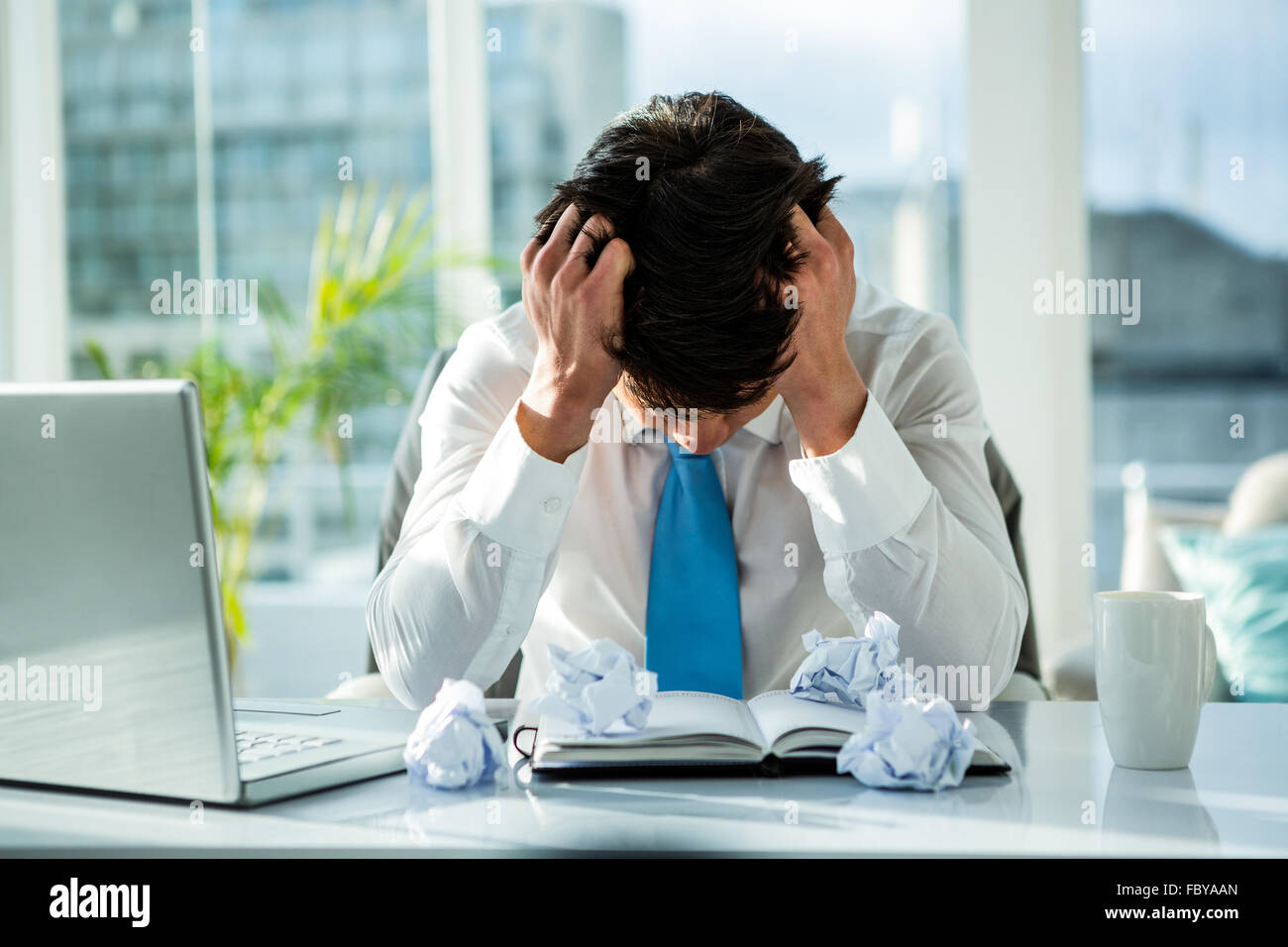 Overwhelmed asian businessman going crazy Stock Photo - Alamy