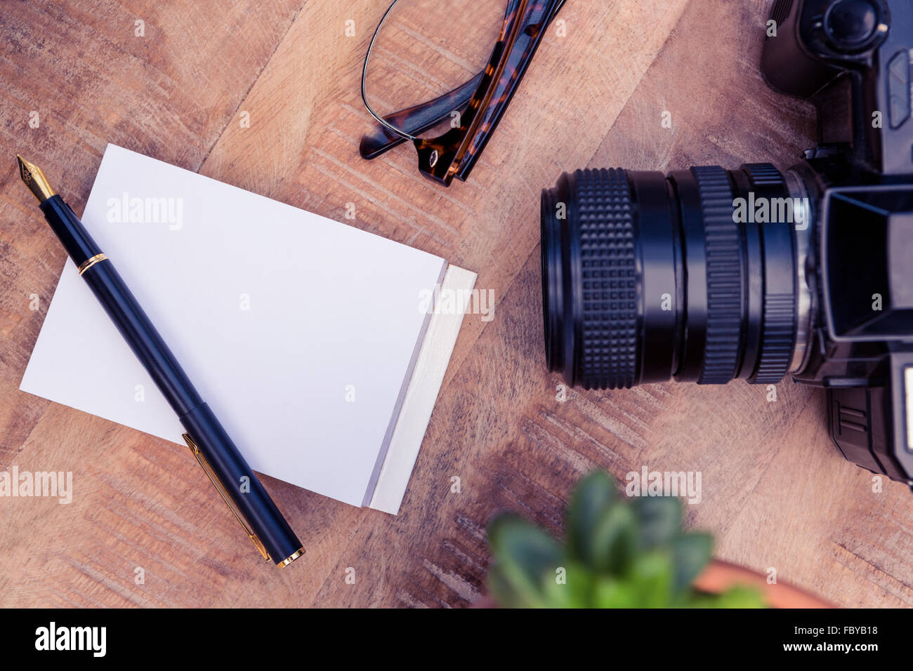 Photo camera on office table with notepad hi-res stock photography and ...