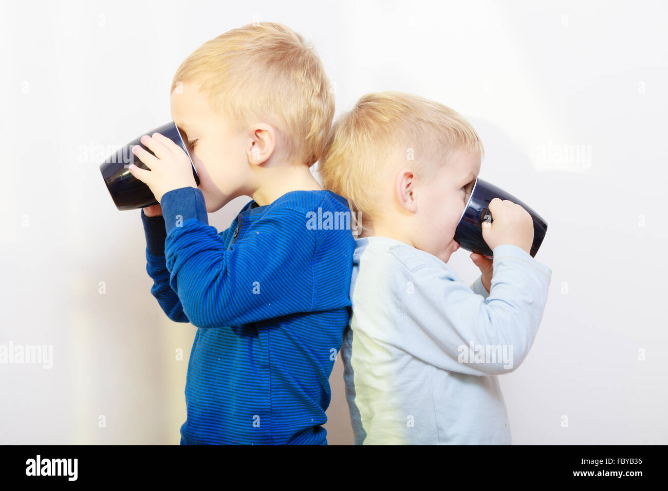 Happy childhood. Two brothers little boys drinking tea Stock Photo - Alamy