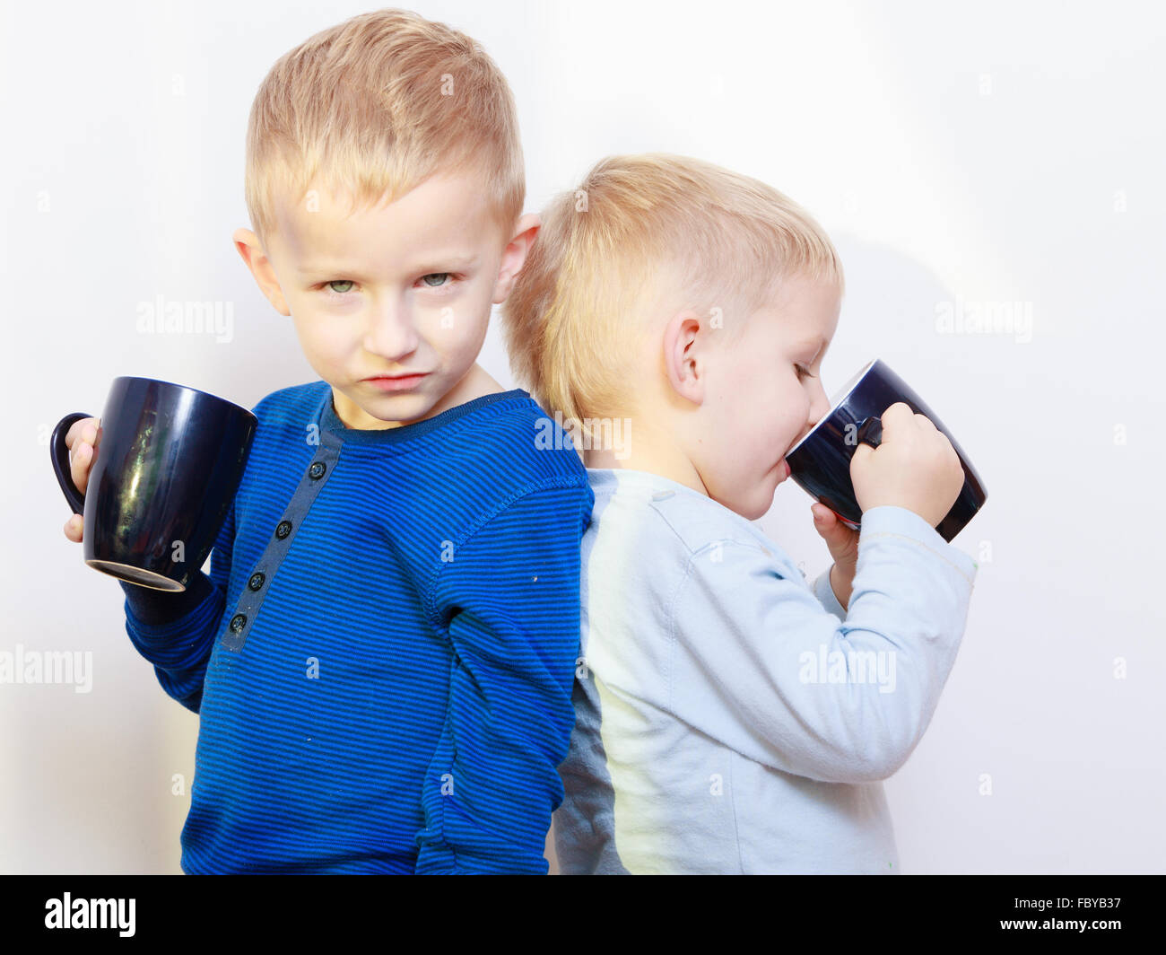 Happy childhood. Two brothers little boys drinking tea Stock Photo - Alamy