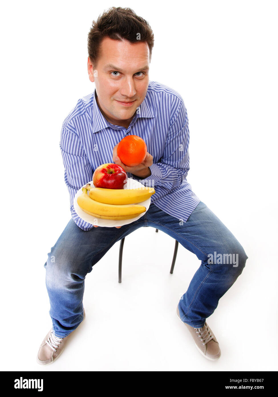 young man with fruits full length isolated Stock Photo - Alamy
