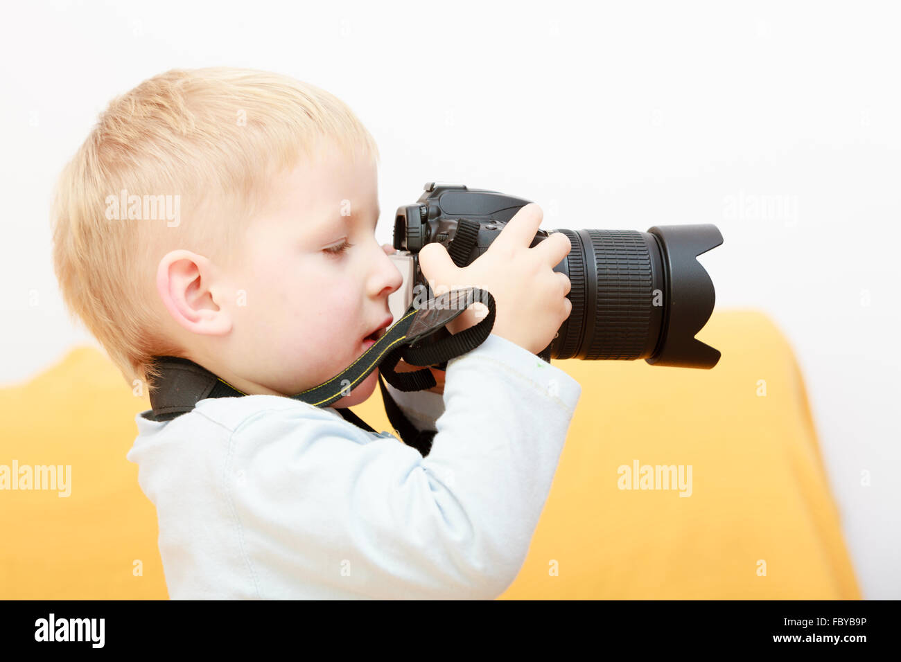 Boy child kid playing with camera taking photo. At home Stock Photo - Alamy