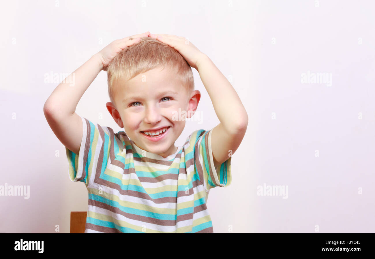 Portrait of surprised emotional blond boy child kid at the table Stock ...