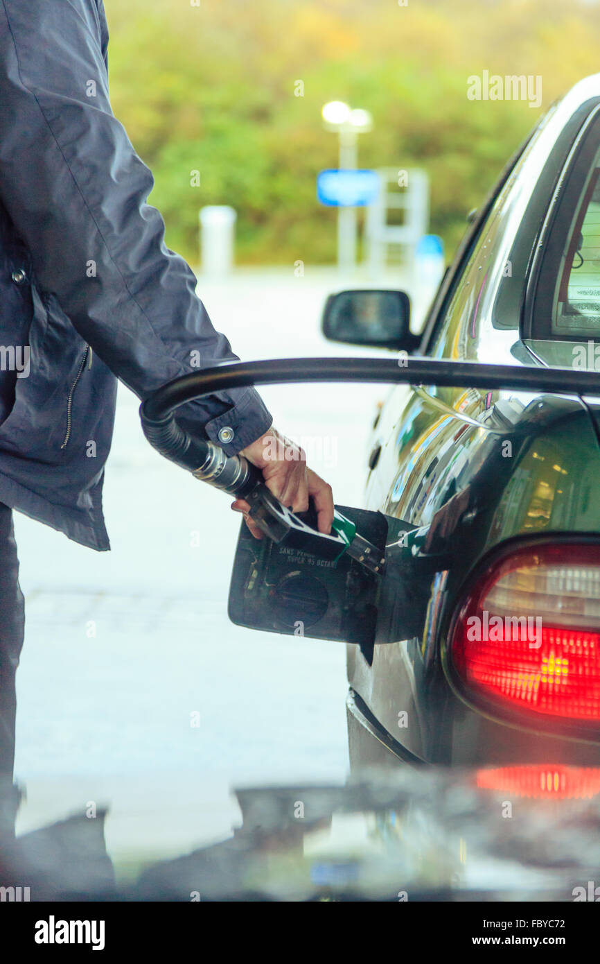 Car refuel fueling at the filling station, holding a fuel pump Stock ...