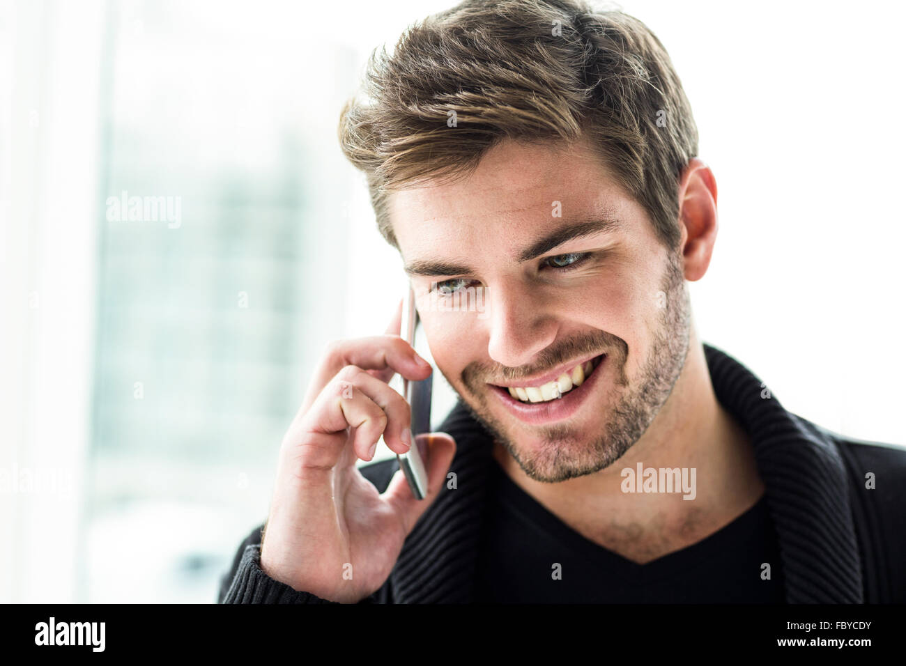 Handsome man smiling on phone call Stock Photo - Alamy