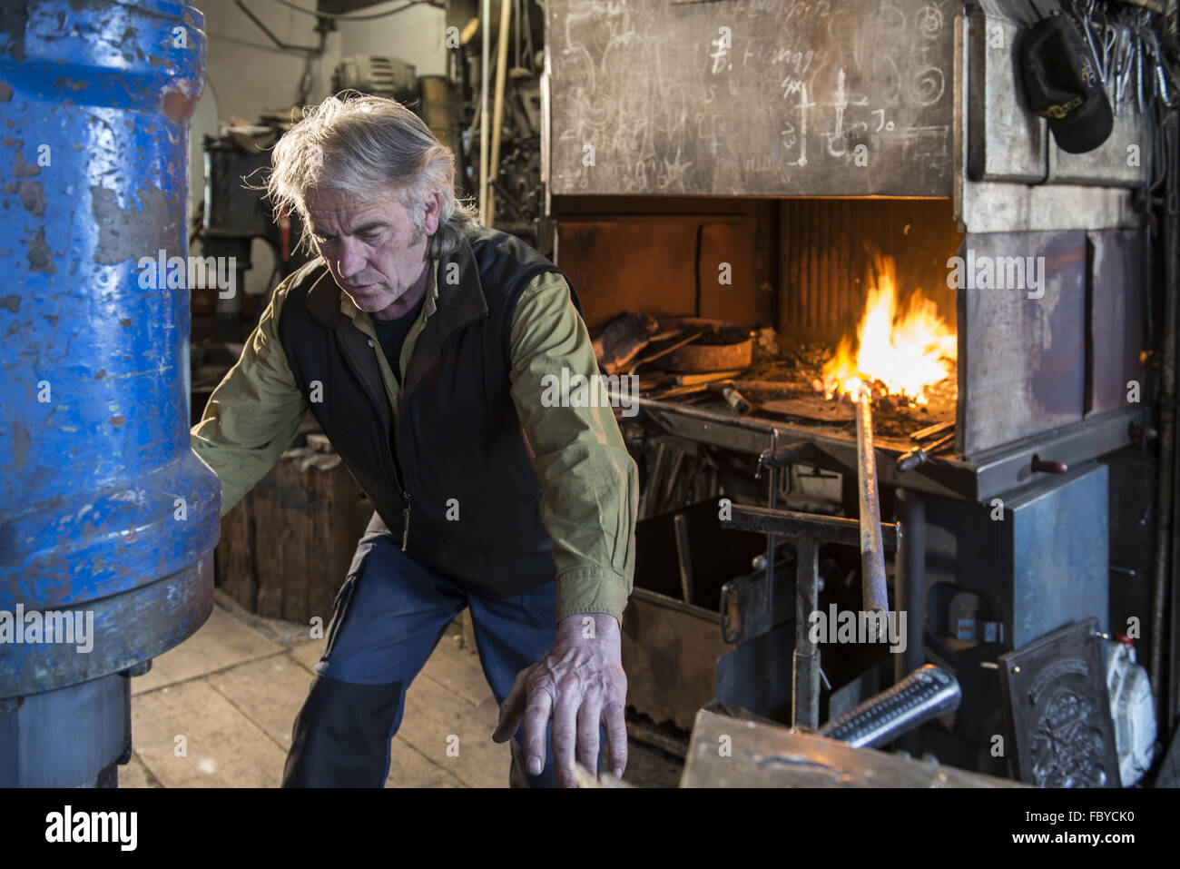 Blacksmith working on Electro Hammer Stock Photo - Alamy