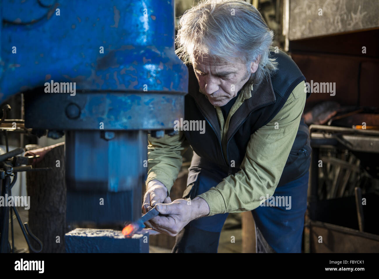 Blacksmith working on Electro Hammer Stock Photo - Alamy