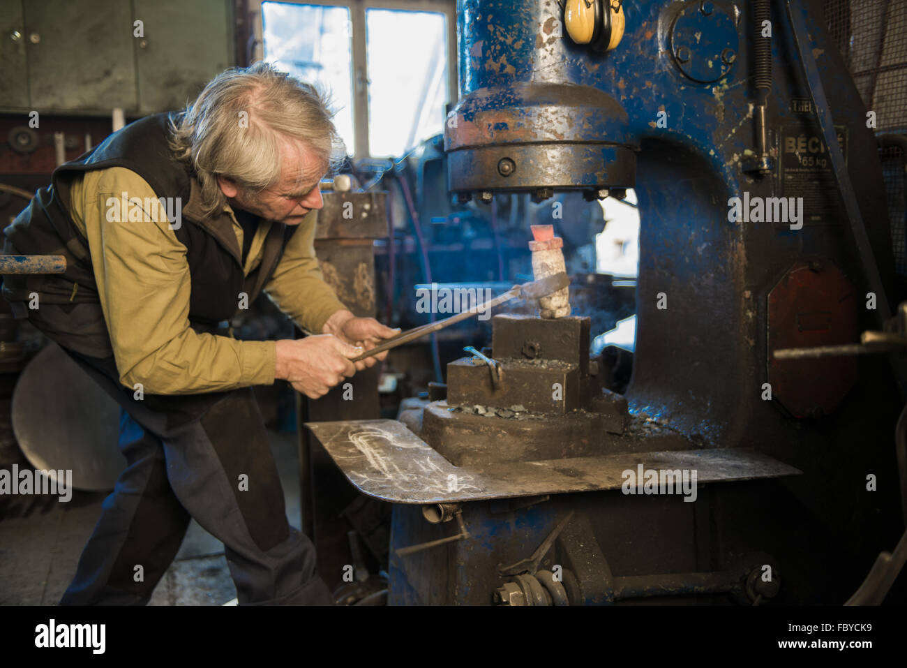 Blacksmith working on Electro Hammer Stock Photo - Alamy