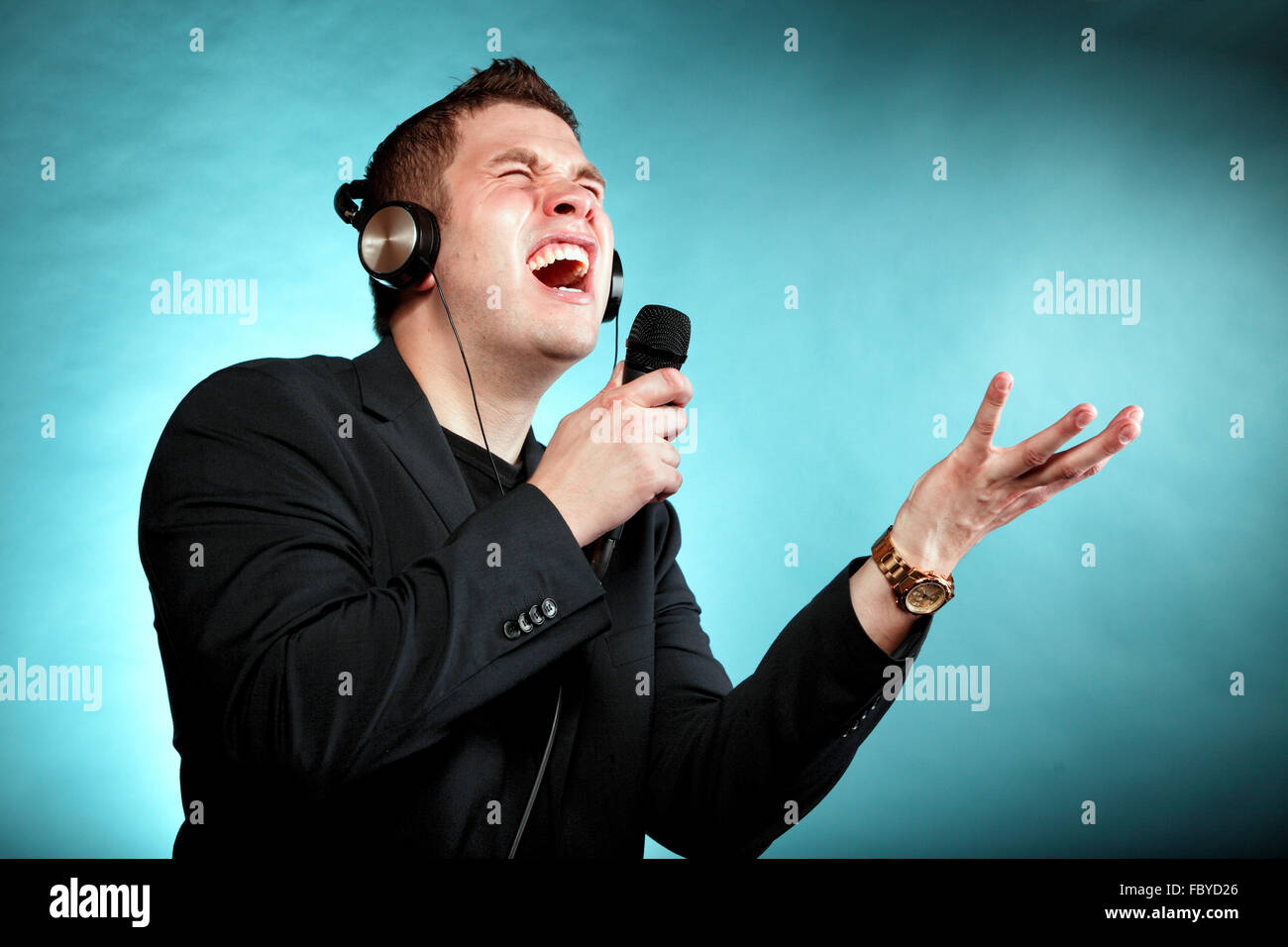 Man singing into microphone hi-res stock photography and images - Alamy