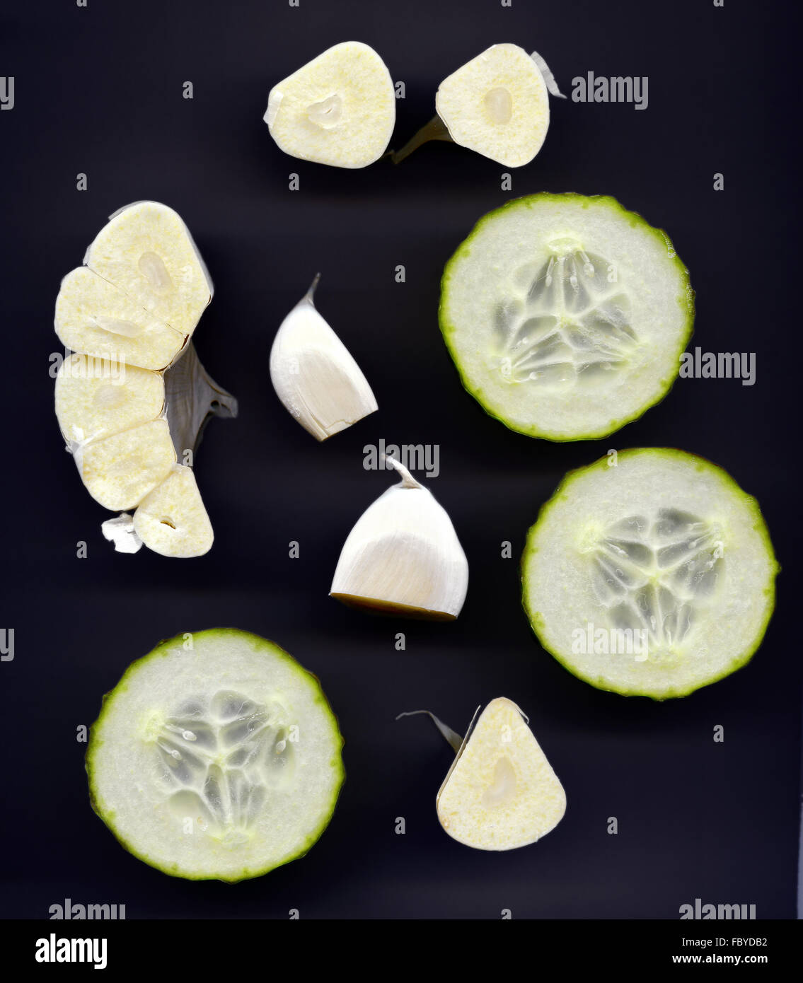 cucumber slices and garlic cloves on black Stock Photo - Alamy