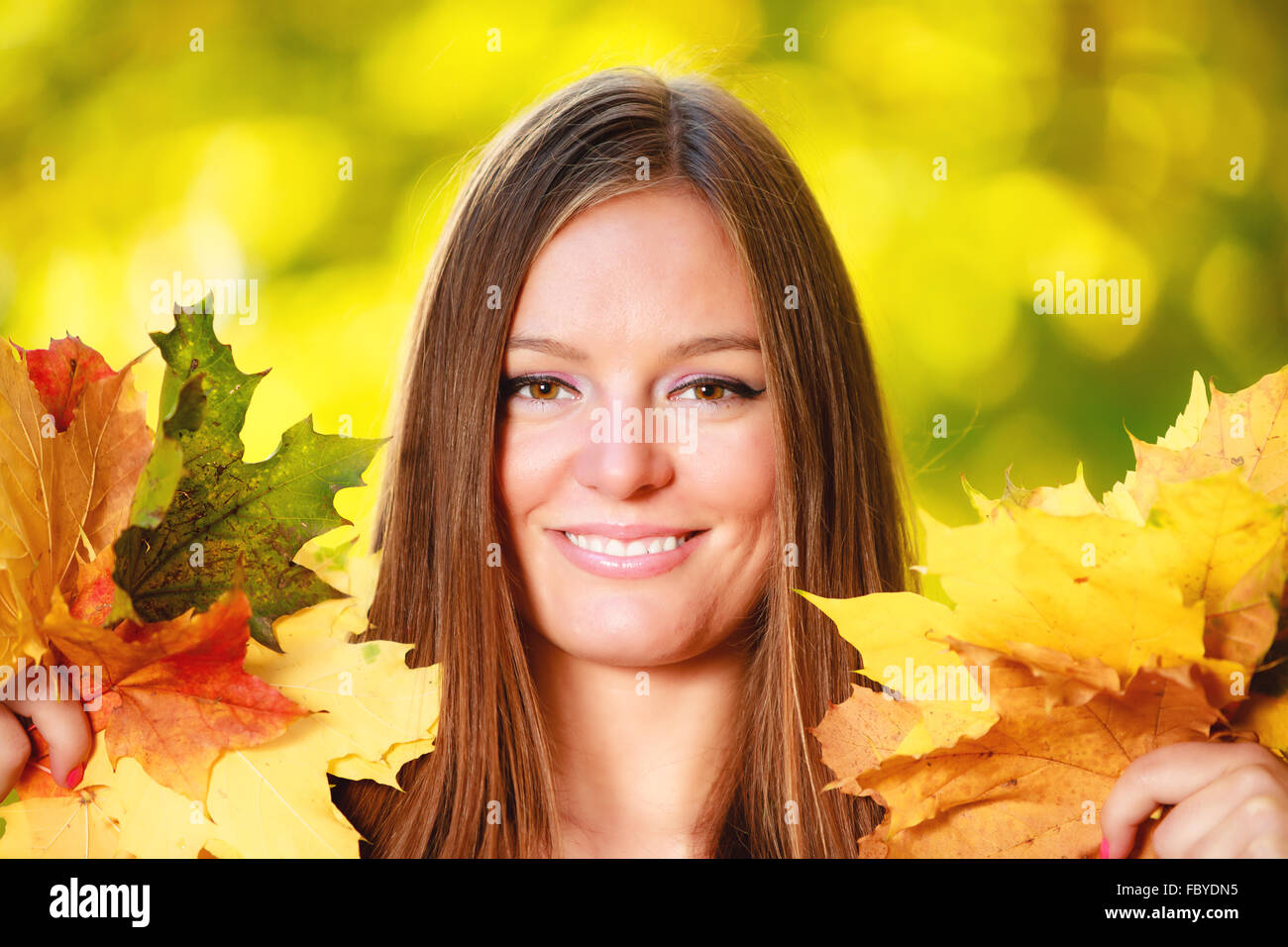 Fall season. Portrait girl woman holding autumnal leaves in park Stock ...