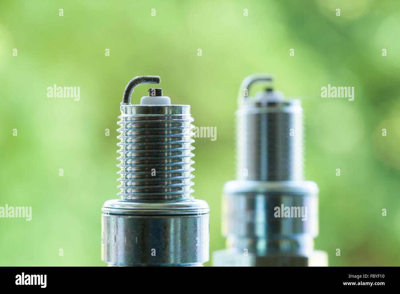 Auto service. Two new spark plugs as spare part of car Stock Photo - Alamy