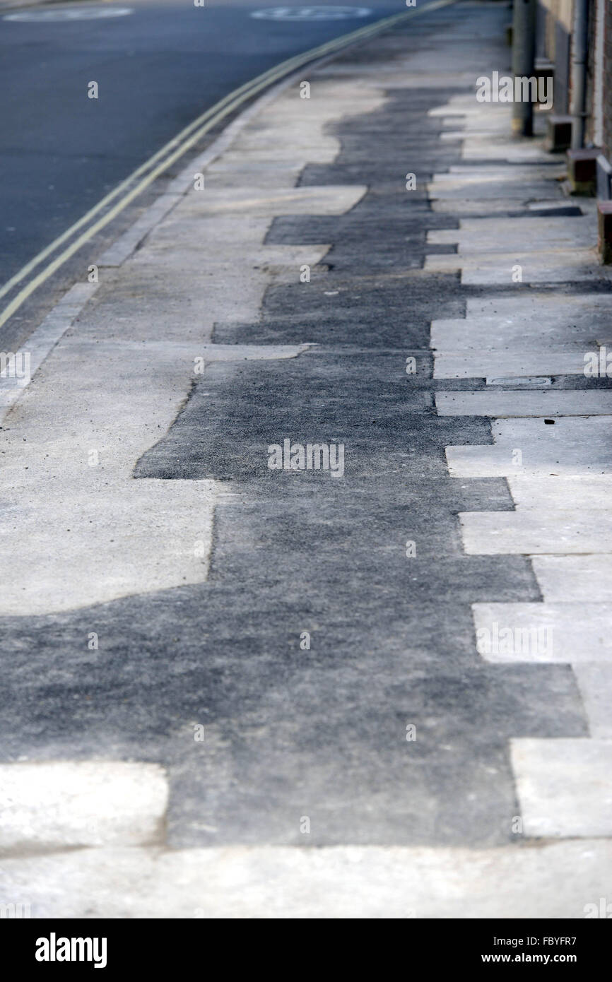Poor and uneven pavement repair Stock Photo - Alamy