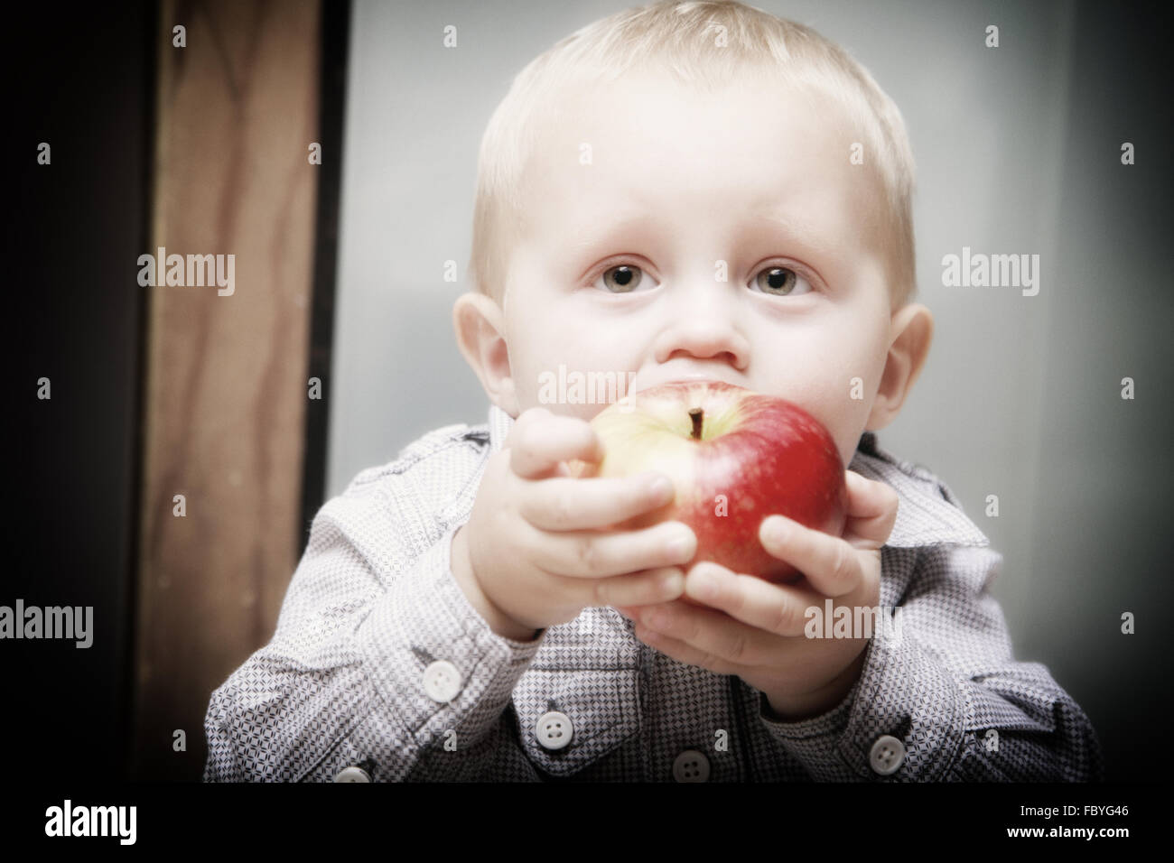 Little boy eating apple Stock Photo - Alamy