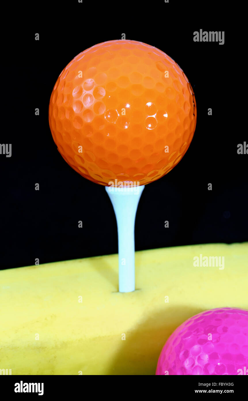 orange golf ball on a tee Stock Photo - Alamy