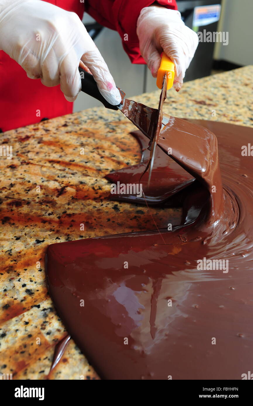 Food Sweets Chocolate making woman tempering chocolate on a cold marble ...